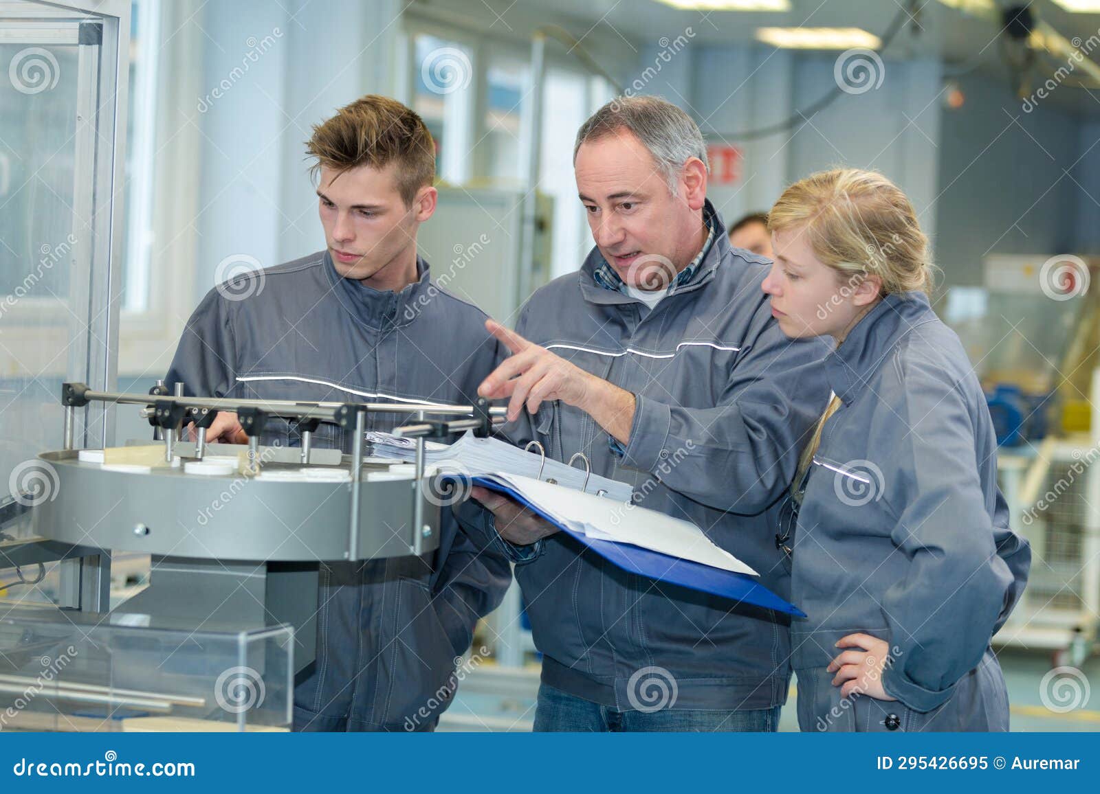 Engineer Working with Apprentices on Factory Floor Stock Image - Image ...