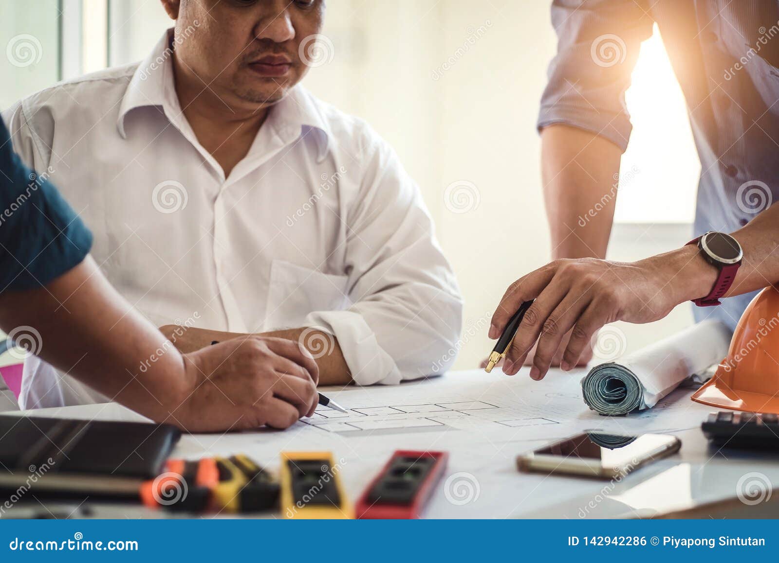 Engineer Working at a Blueprint of House in Office for Discussing Real ...