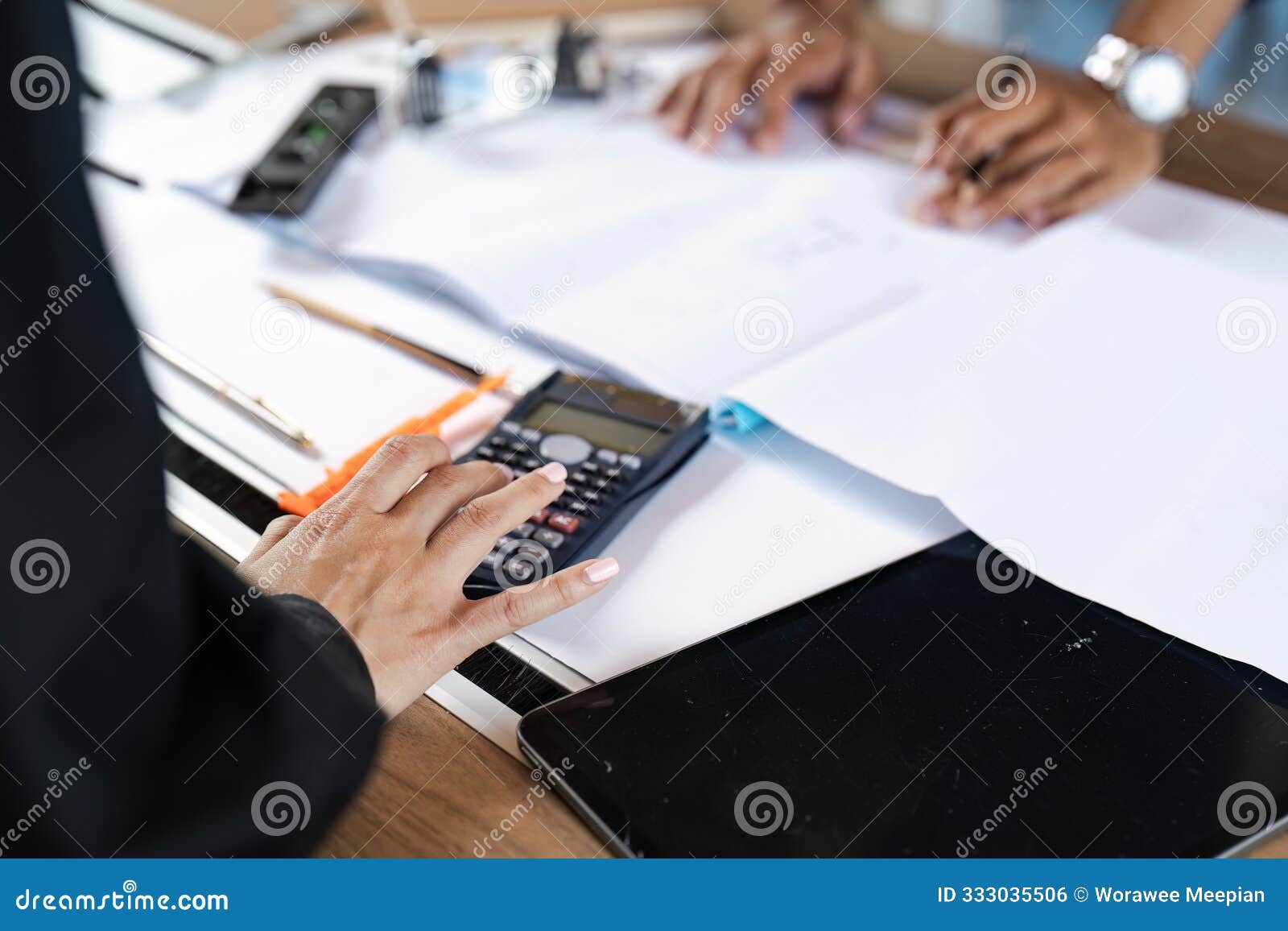 Engineer Working on Blueprints and Calculations with Calculator and ...
