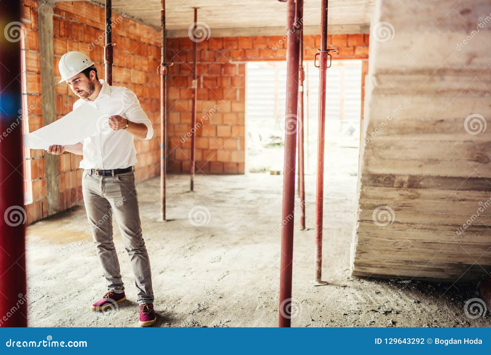 Engineer Working on Construction Site, Inside Interior Brick Walls ...
