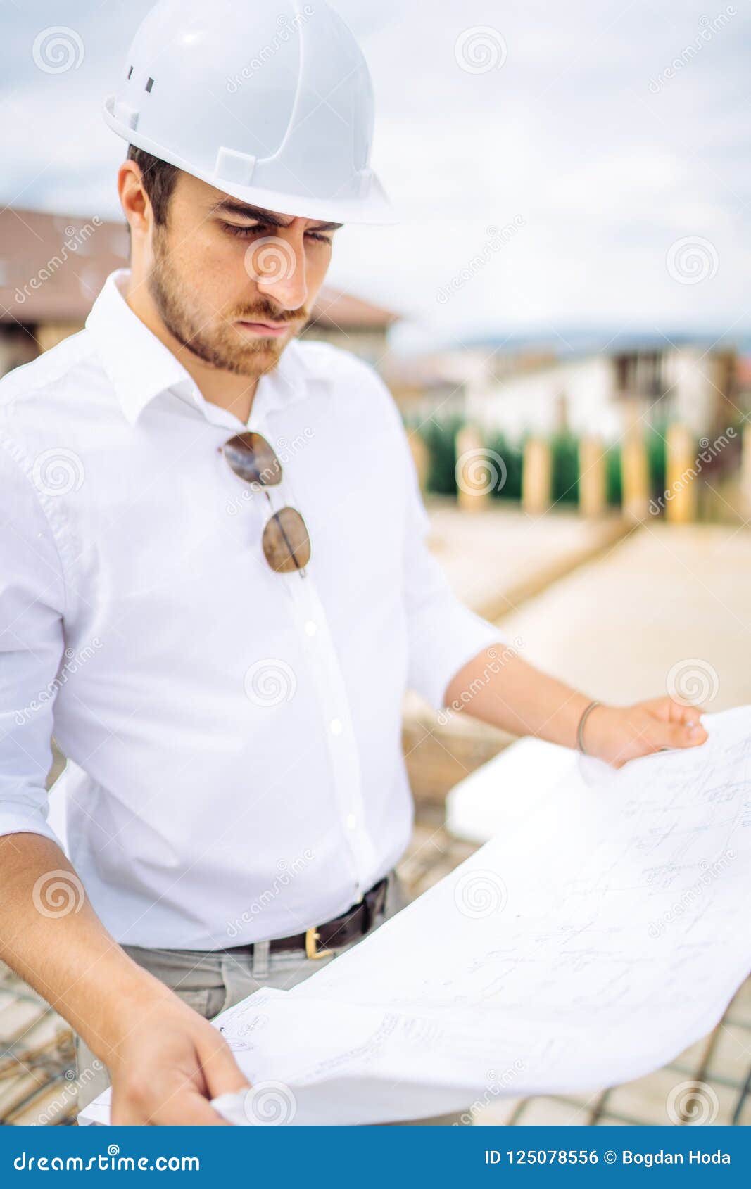 Engineer Working on Construction Site, Reading Building Project and ...