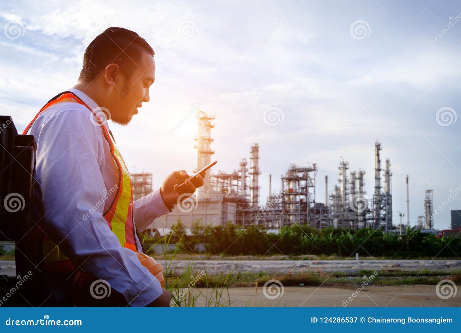 The Engineer is Working with Smart Phone with Large Industry Background ...