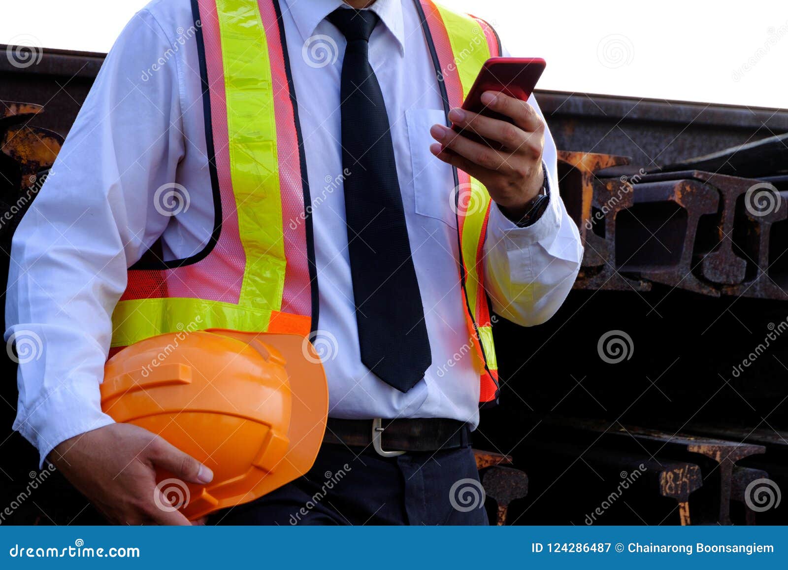 The Engineer is Working with Smart Phone with Large Industry Background ...