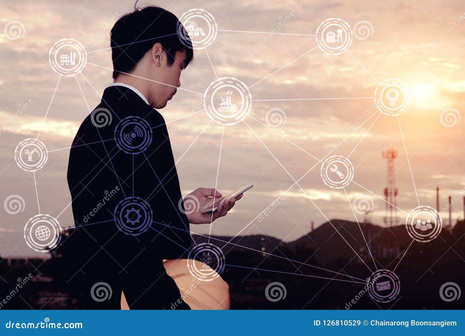 Engineer is Working with Smart Phone on Large Industry Background ...