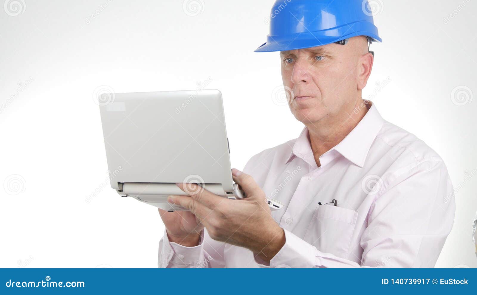 Engineer Working Using a Laptop Accessing on Line Technical Information ...
