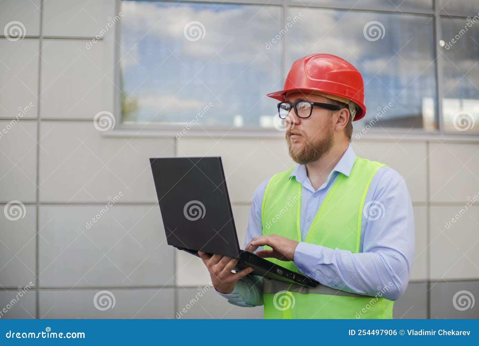 Engineer works on laptop stock photo. Image of helmet - 254497906