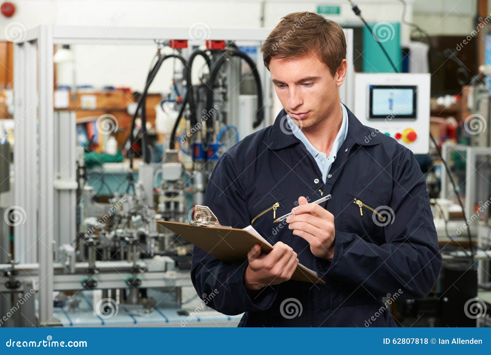 Engineer Writing on Clipboard in Factory Stock Photo - Image of smiling ...