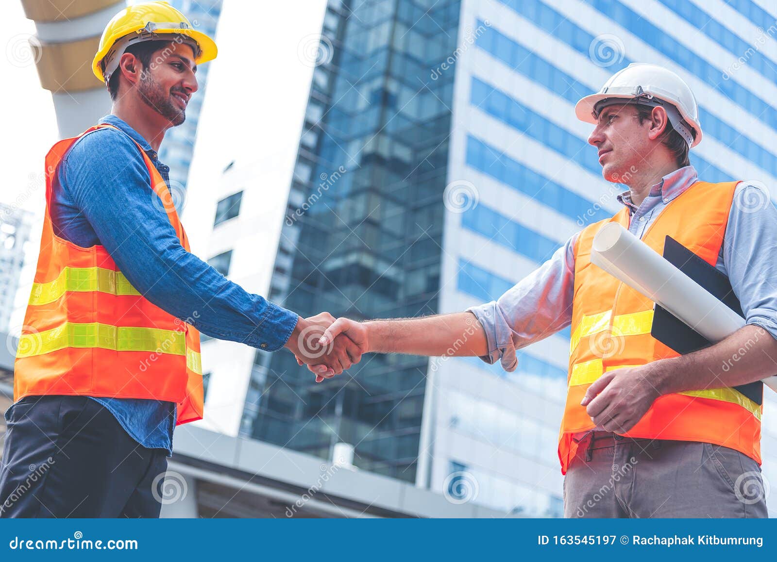 Engineer in Yellow Helmet and Best Greeting with Warm Handshake Manager ...