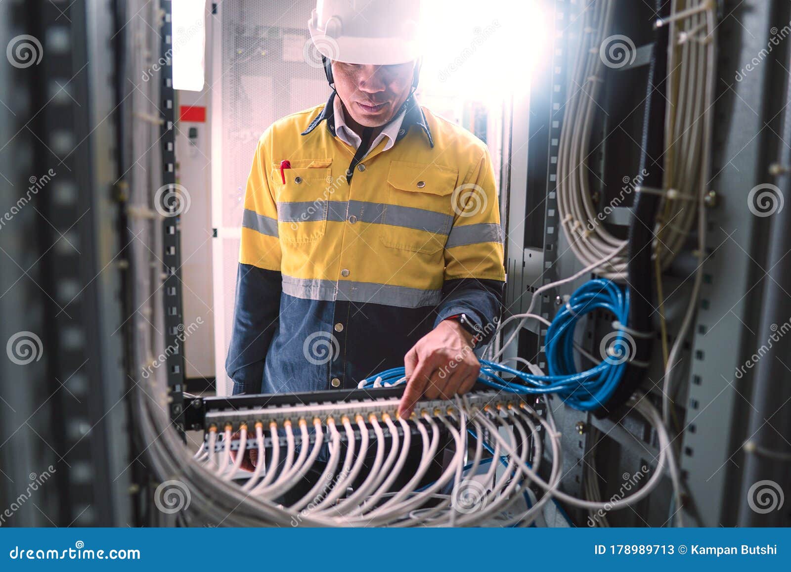 Engineer in Yellow Uniform, Wearing a White Safety Helmet, Checking ...