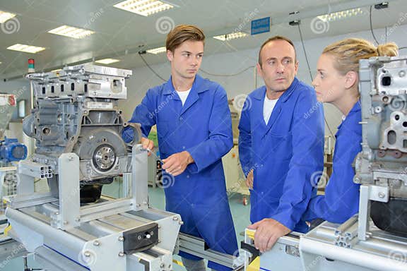Engineering Apprentices with Instructor Stock Photo - Image of ...