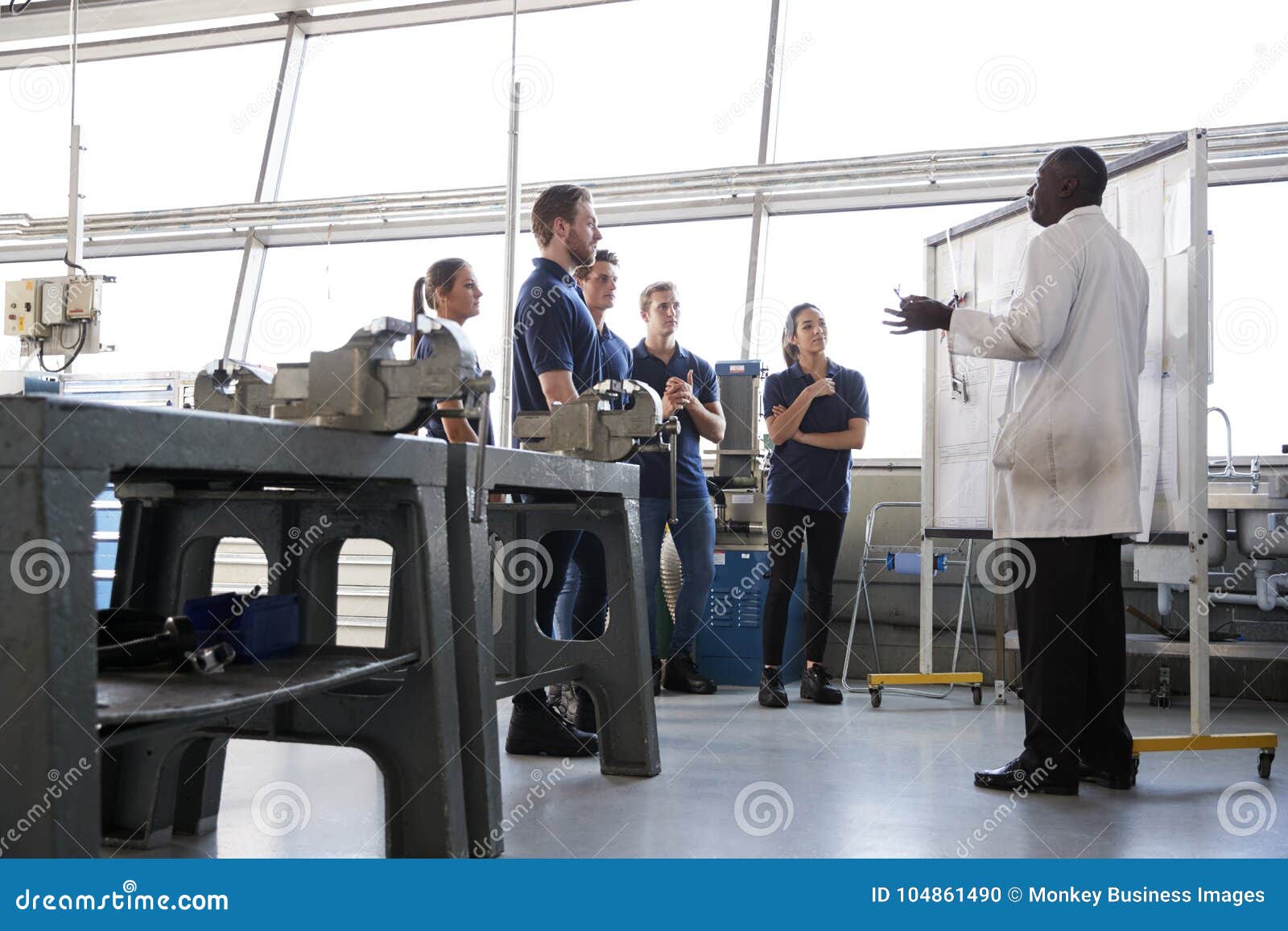 Engineering Apprentices Stand at a Training Presentation, Low Angle ...