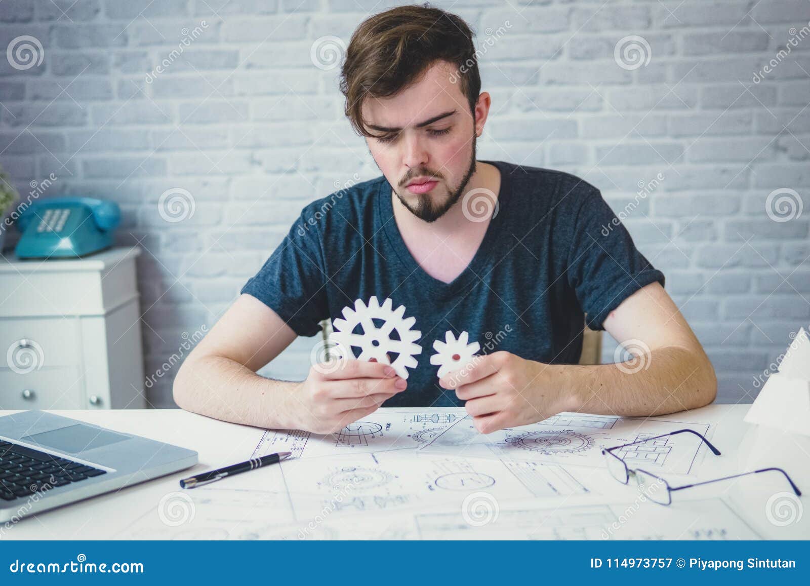 Engineering Man Working on Blueprint for Designing Mechanical Pa Stock ...
