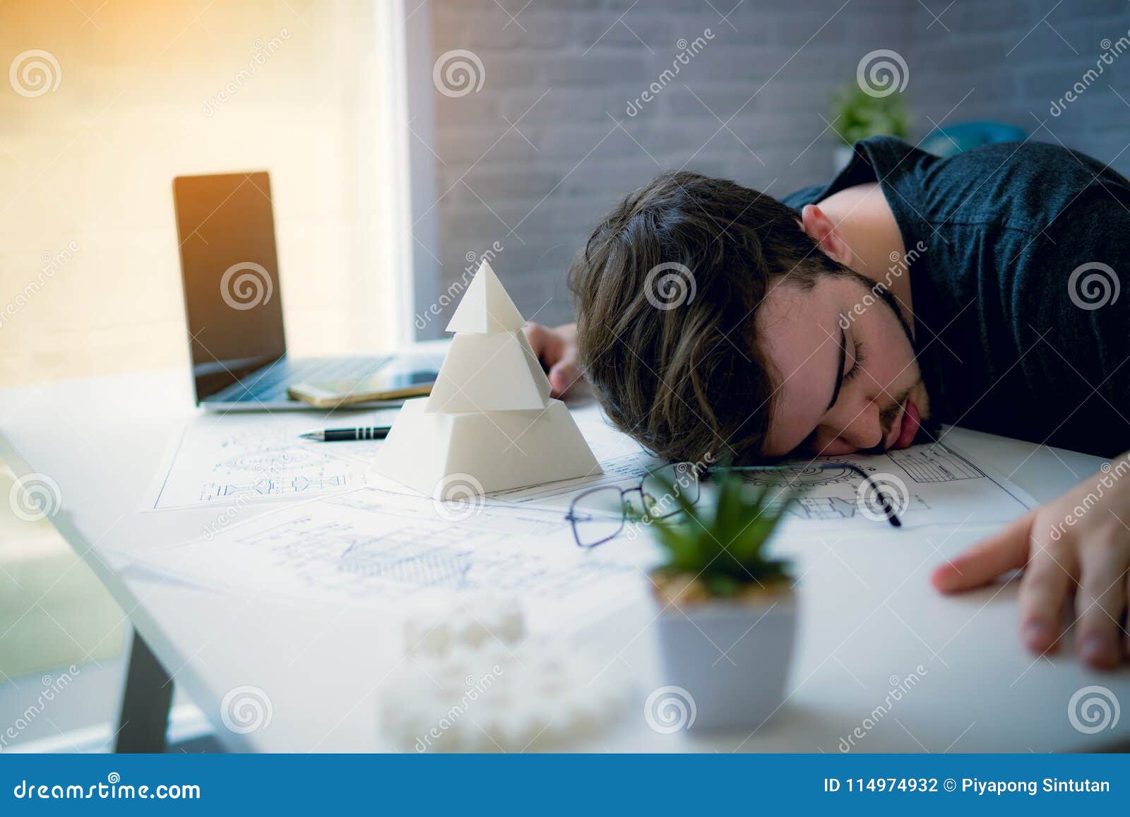 Engineering Man Working Overwork and Sleep on the Desk with Blue Stock ...