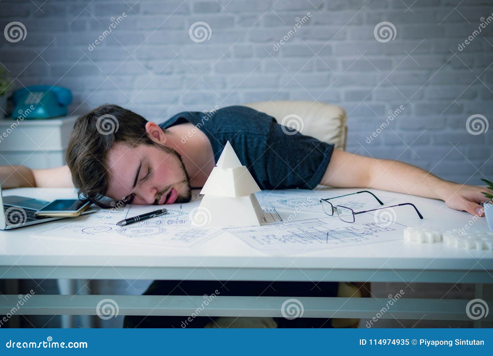 Engineering Man Working Overwork and Sleep on the Desk with Blue Stock ...