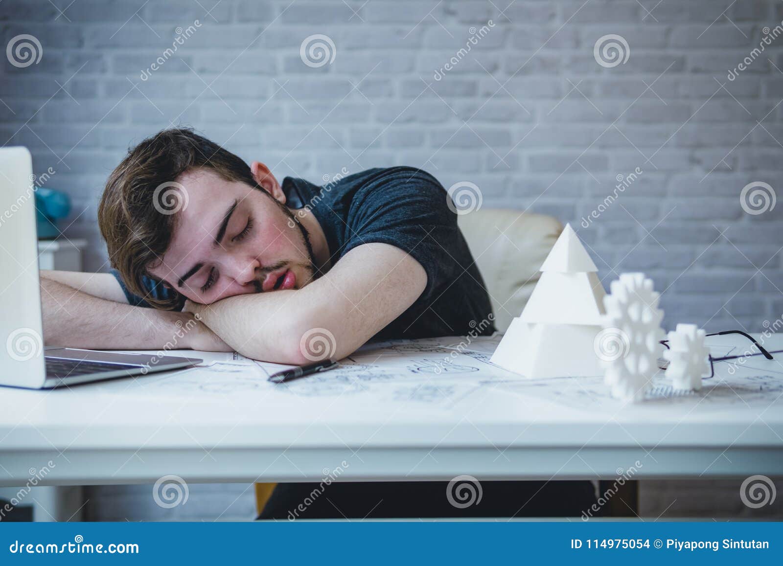 Engineering Man Working Overwork and Sleep on the Desk with Blue Stock ...