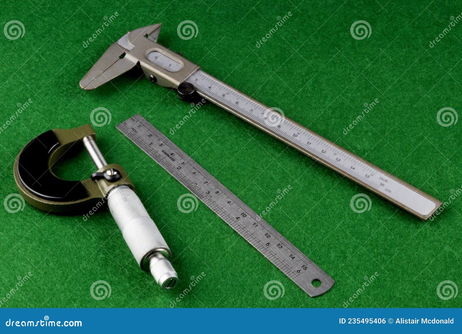 Micrometer with Vernier Caliper and Steel Ruler on a Felt Surface Stock ...