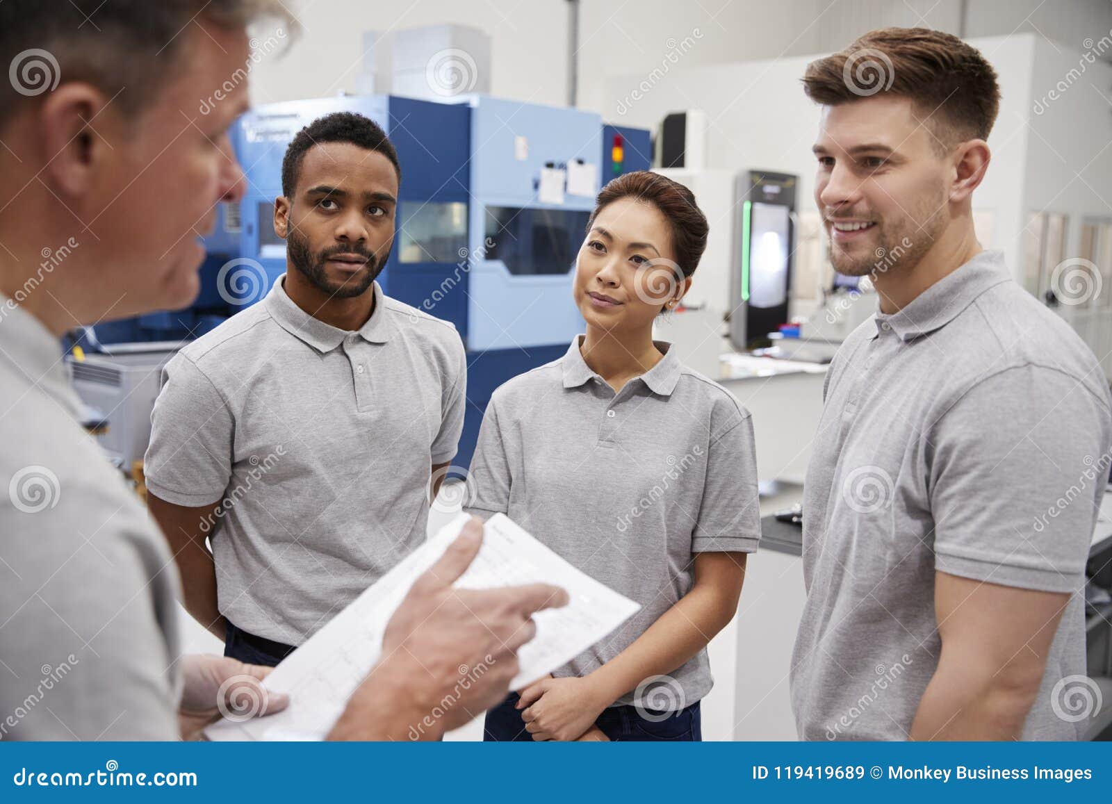 Engineering Team Meeting on Factory Floor of Busy Workshop Stock Image ...