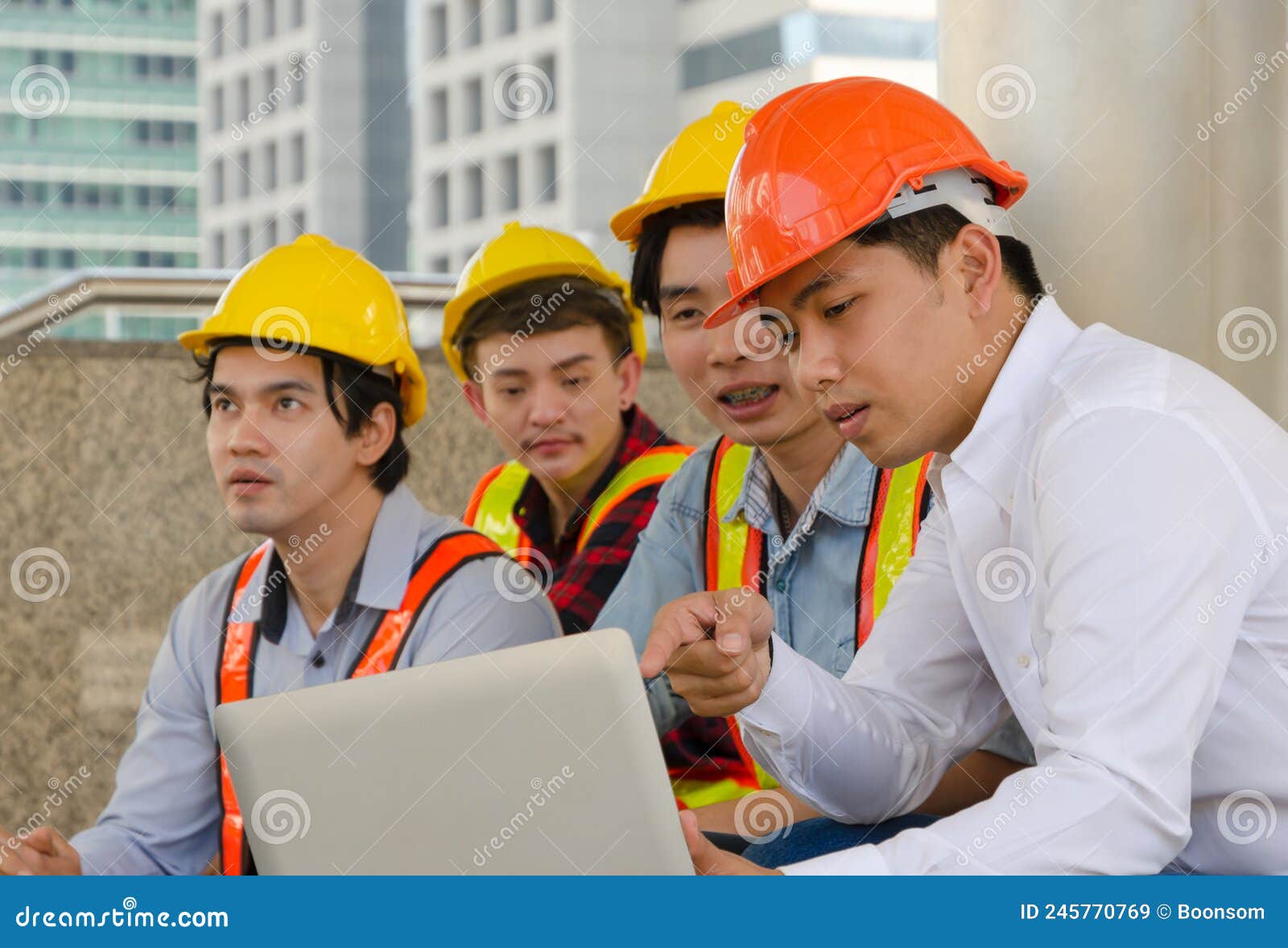 Engineering Team Working Together on Building Site and Using Laptop for ...