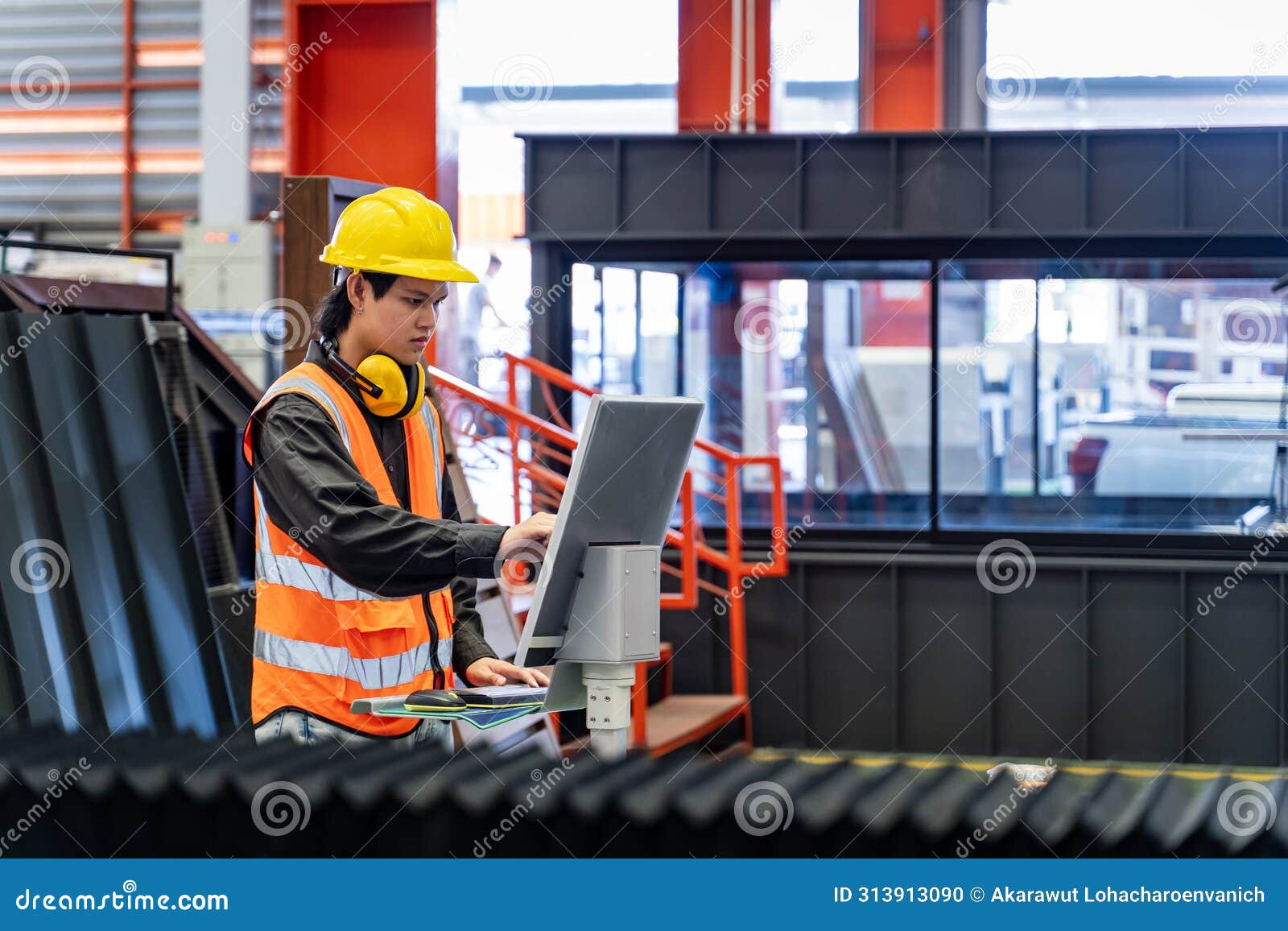 Engineering Technician Worker is Operating the Machine Inside Factory Using Touch Screen ...