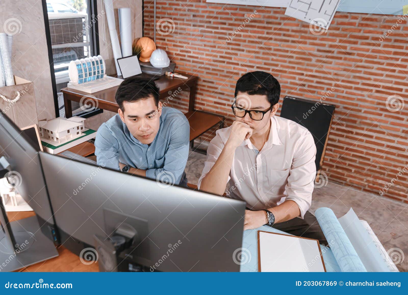 Engineers and Architect Reading a Building and Drawing Outlay ...