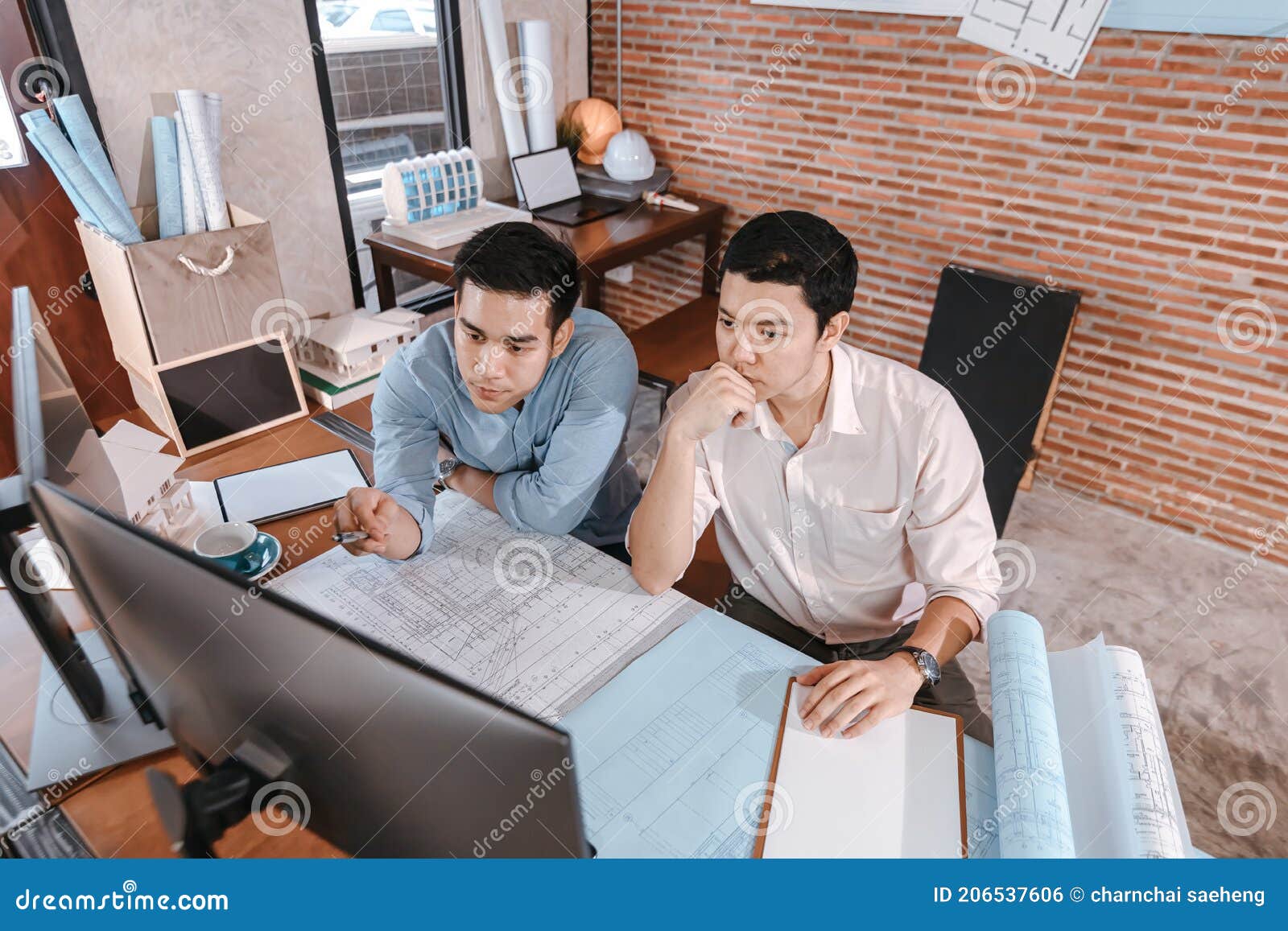 Engineers and Architect Reading a Building and Drawing Outlay ...