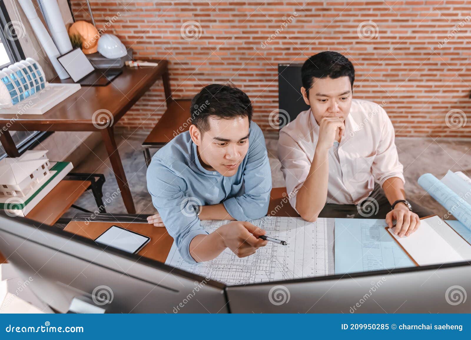 Engineers and Architect Reading a Building and Drawing Outlay ...