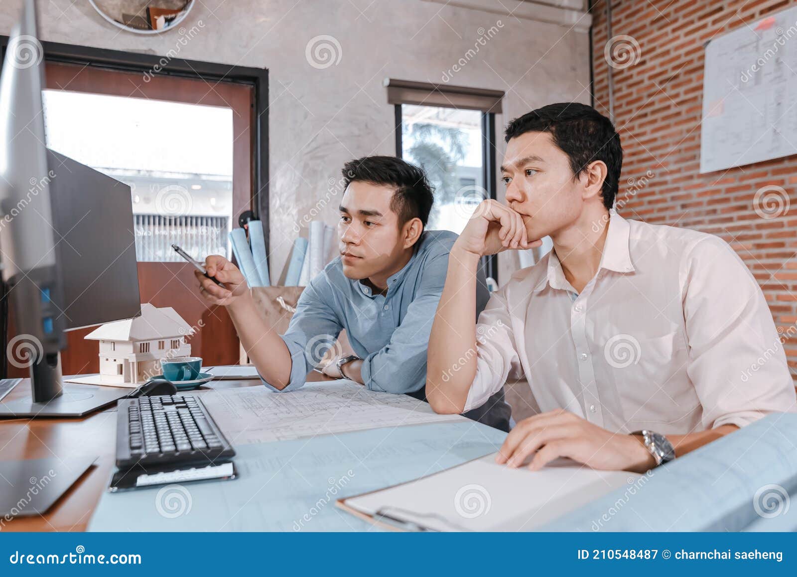 Engineers and Architect Reading a Building and Drawing Outlay ...