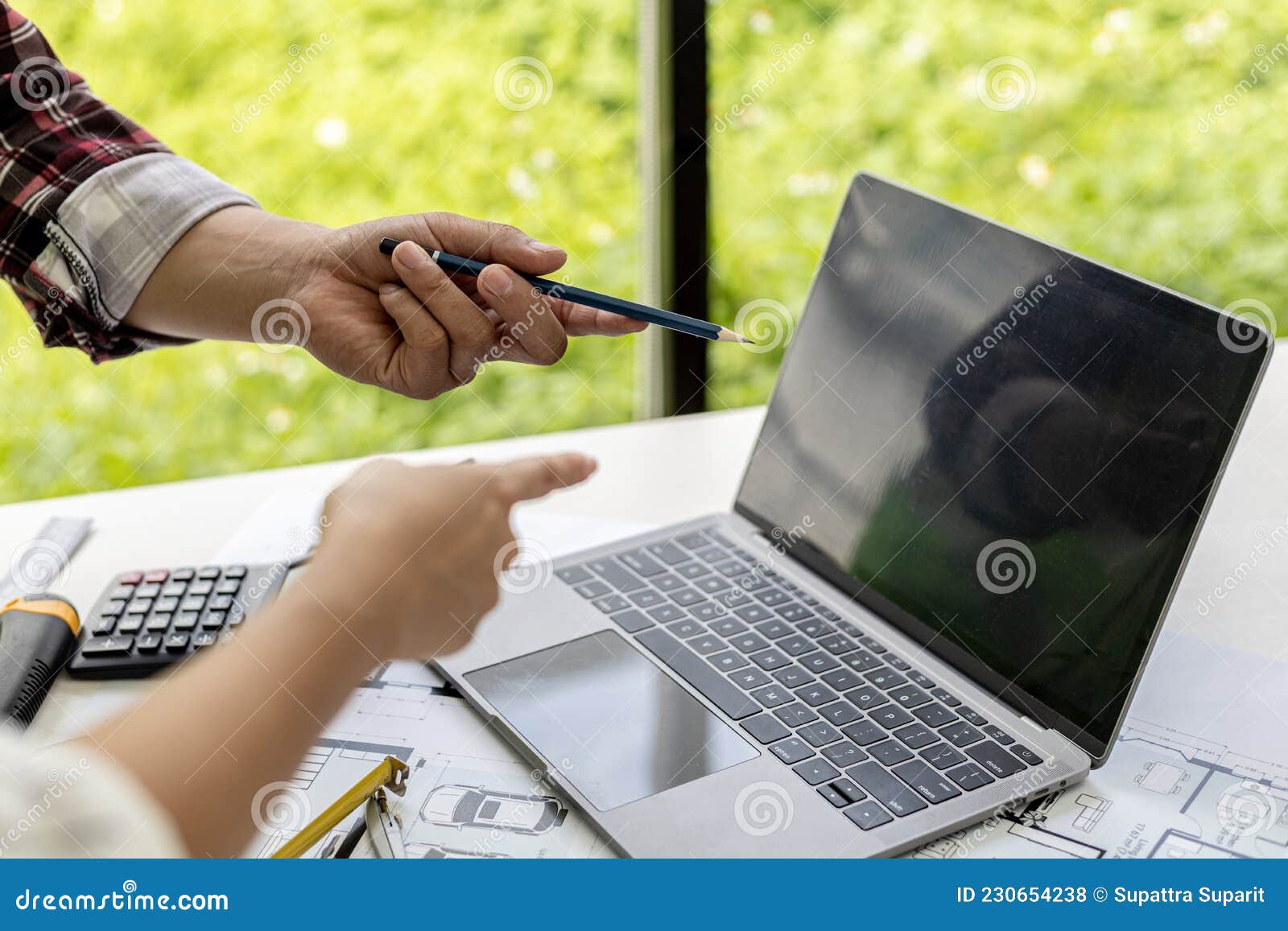 Engineers and Architects Pointing at Laptop Screens Looking at ...