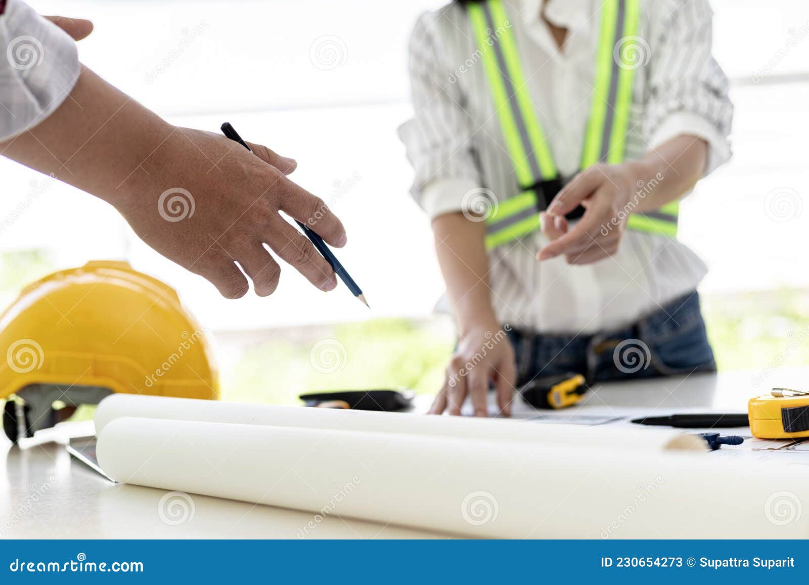 Engineers and Architects Pointing To the House Blueprints Designed for ...