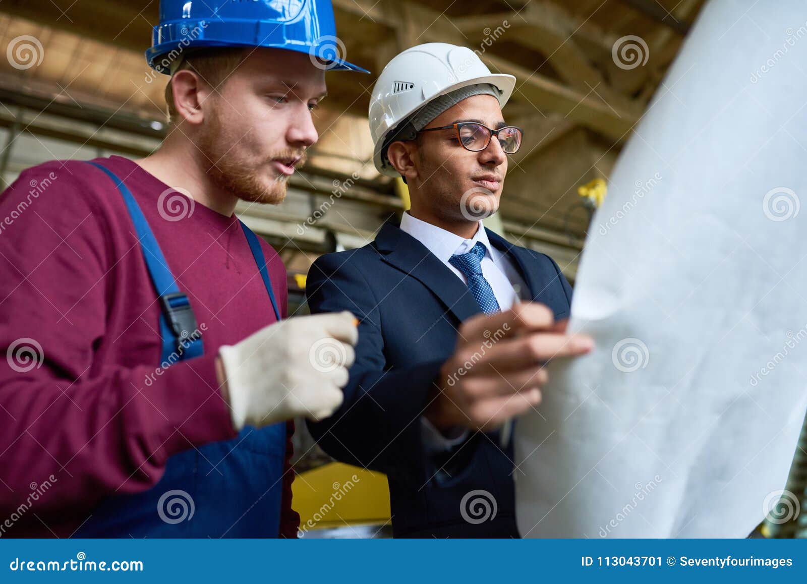Engineers Discussing Blueprints Stock Image - Image of plant, workshop ...