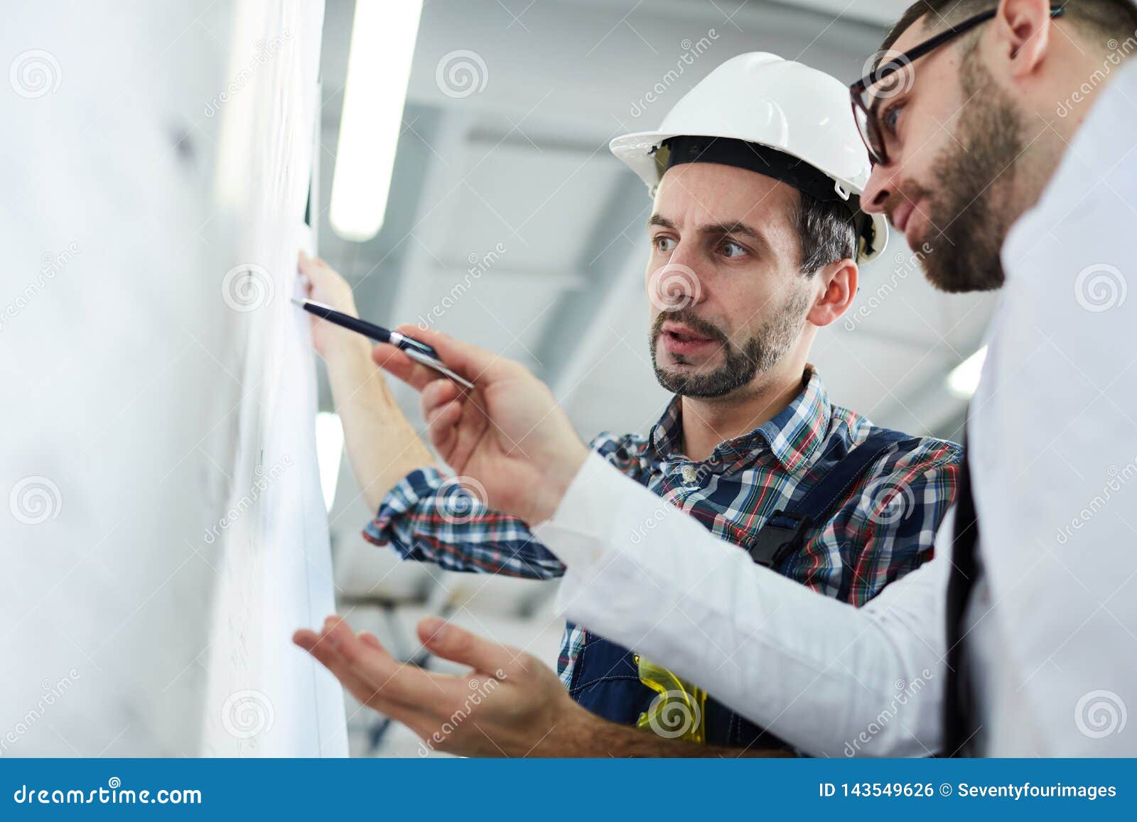 Engineers Discussing Blueprints Stock Photo - Image of plant, pointing ...