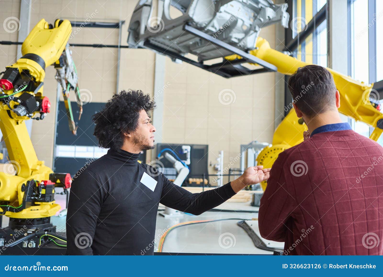 Engineers Discussing Industrial Robot with Gripper Arm for Automotive Production Stock Photo ...