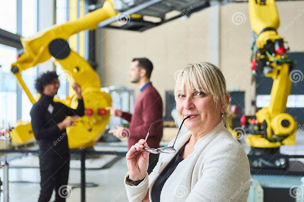 Engineers Discussing Robotics Development in a Modern Industrial Setting Stock Photo - Image of ...