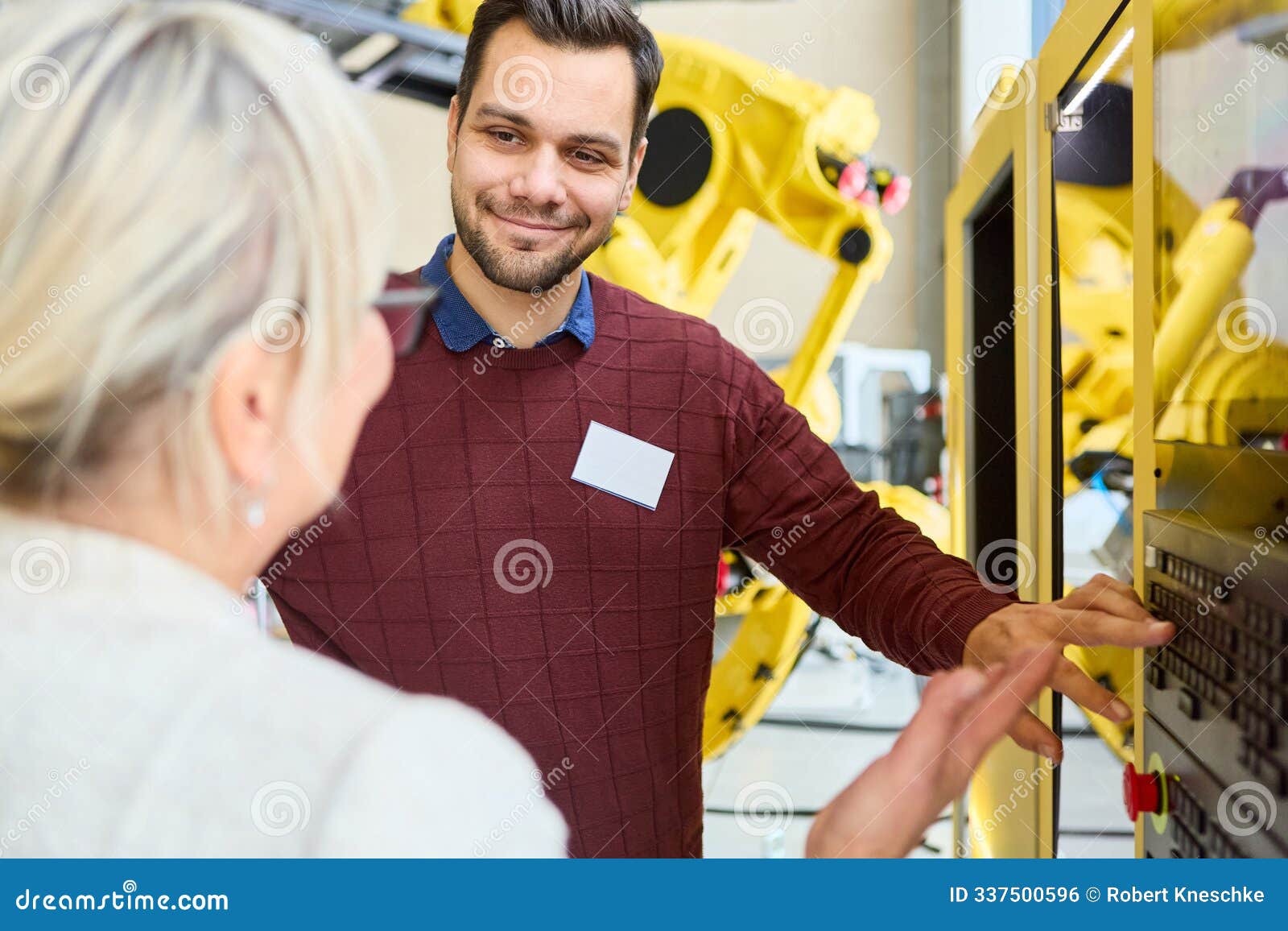 Engineers Discussing Robotics Programming with Multi-purpose Robot in Background Stock Photo ...