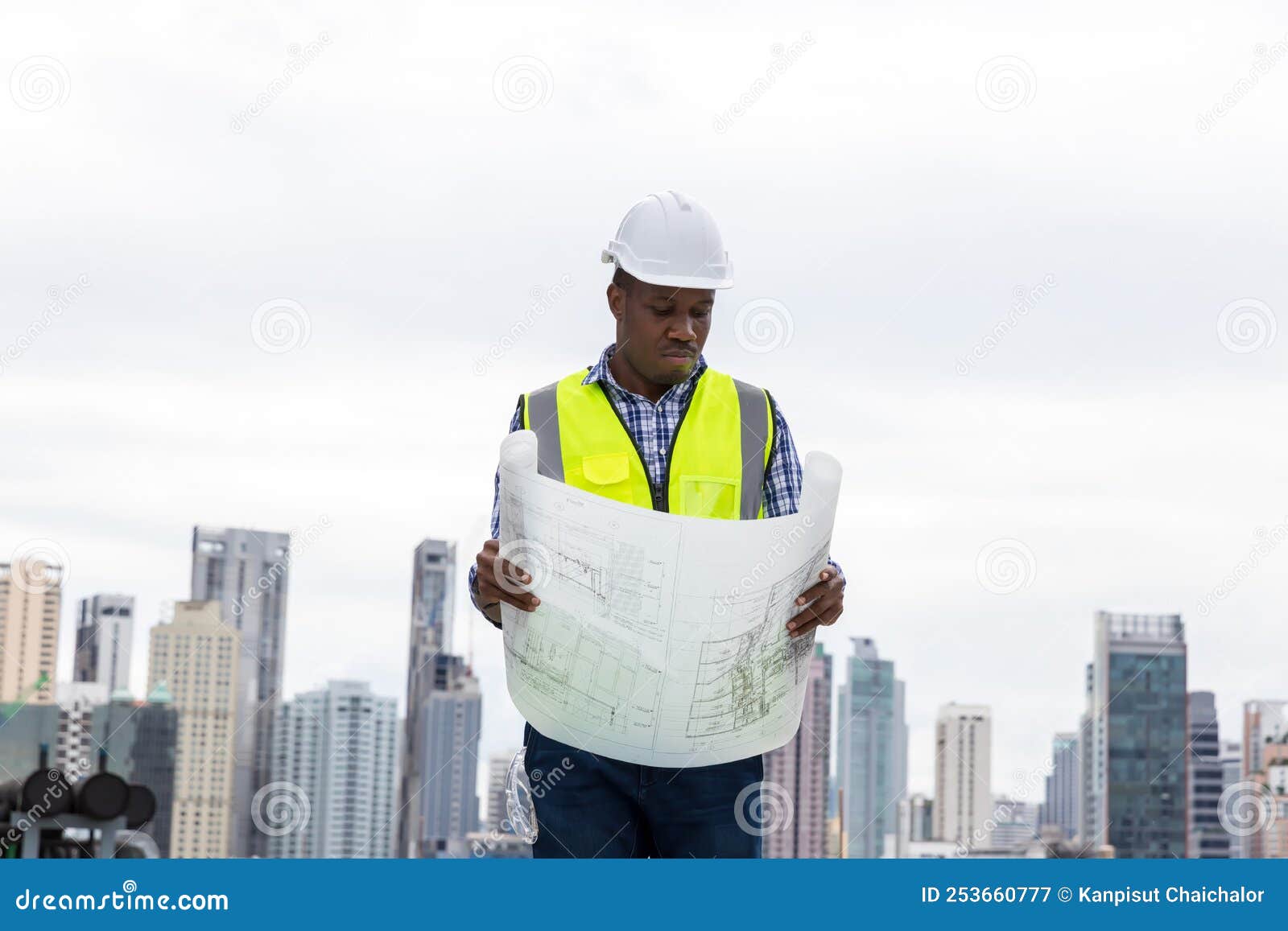 Engineers with Draft Plan of Building on Constructing Site. Engineer ...