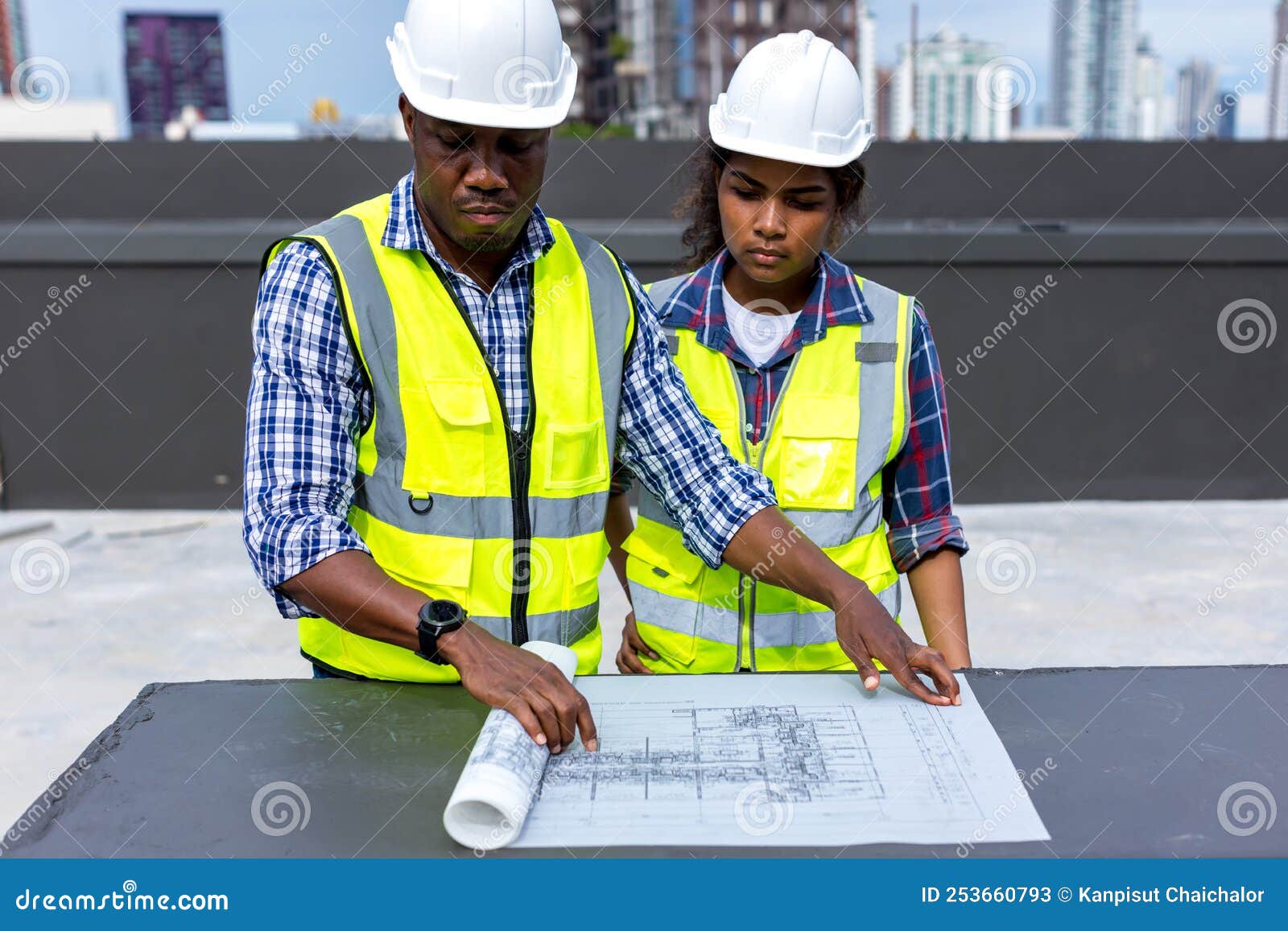Engineers with Draft Plan of Building on Constructing Site. Engineer ...