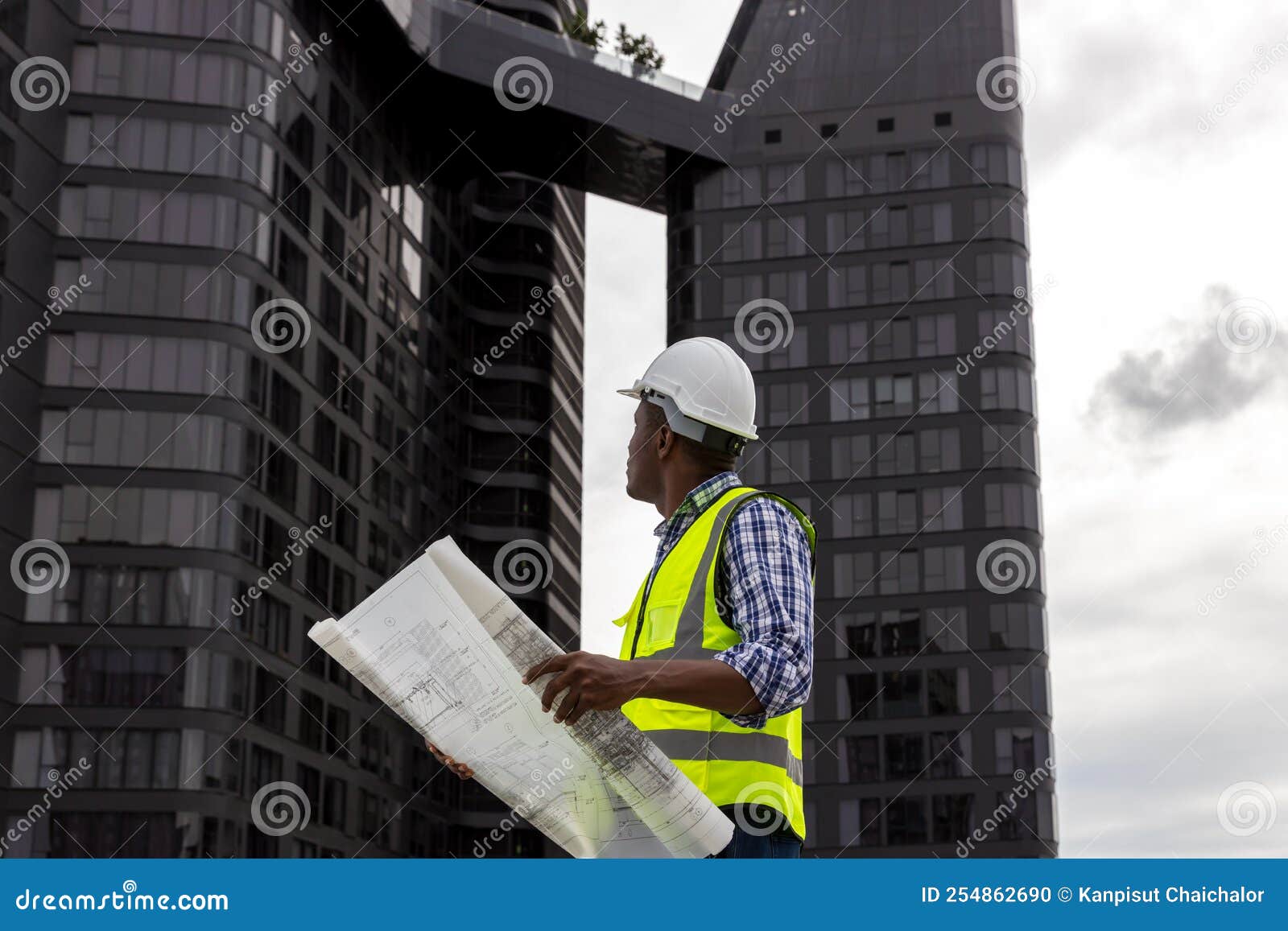 Engineers with Draft Plan of Building on Constructing Site. Engineer ...