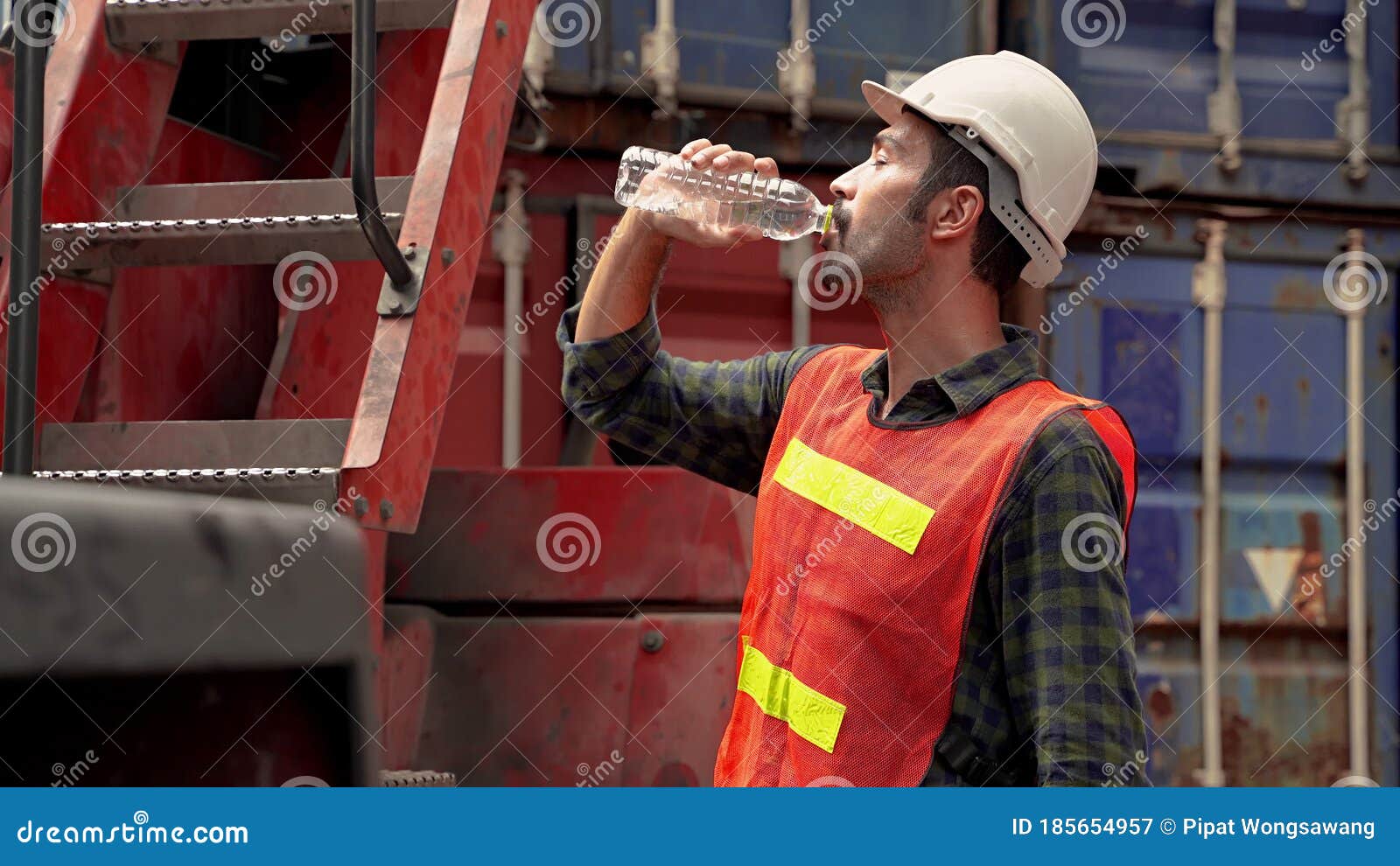 Engineers are Drinking Water from Bottles while Using Radio To ...