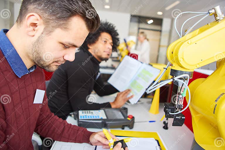 Engineers Programming Industrial Robots in a Training Lab Stock Photo - Image of automation ...