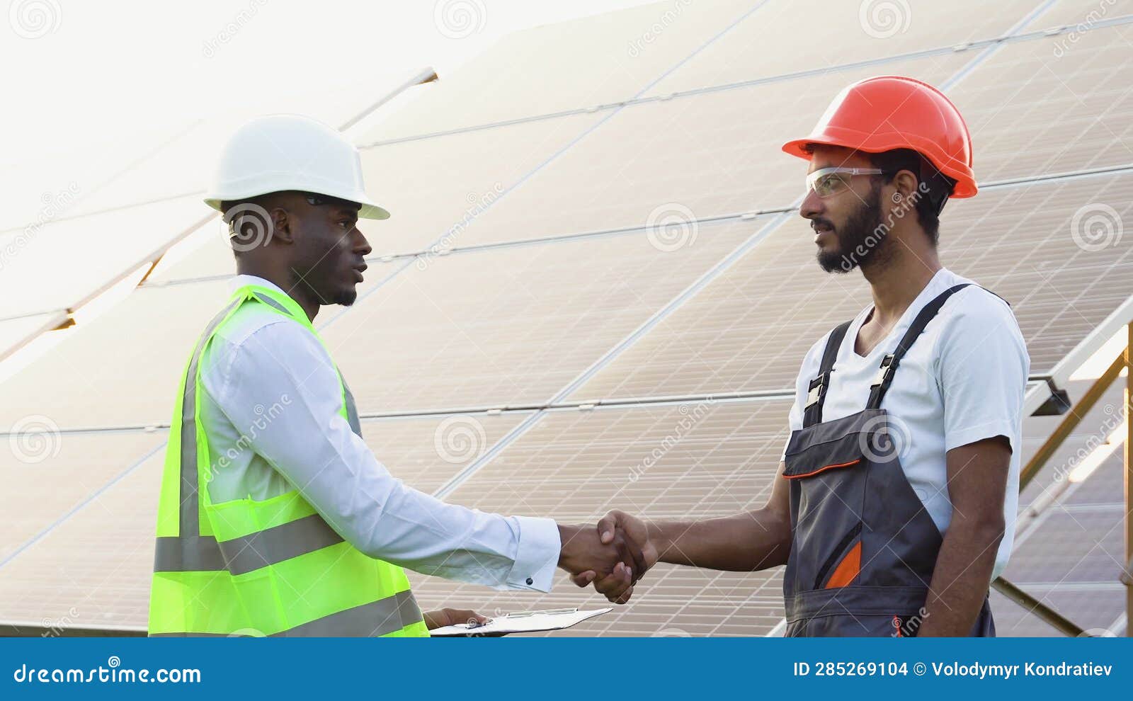 Indian and African Engineers Handshaking in Front of Solar Panels Stock ...