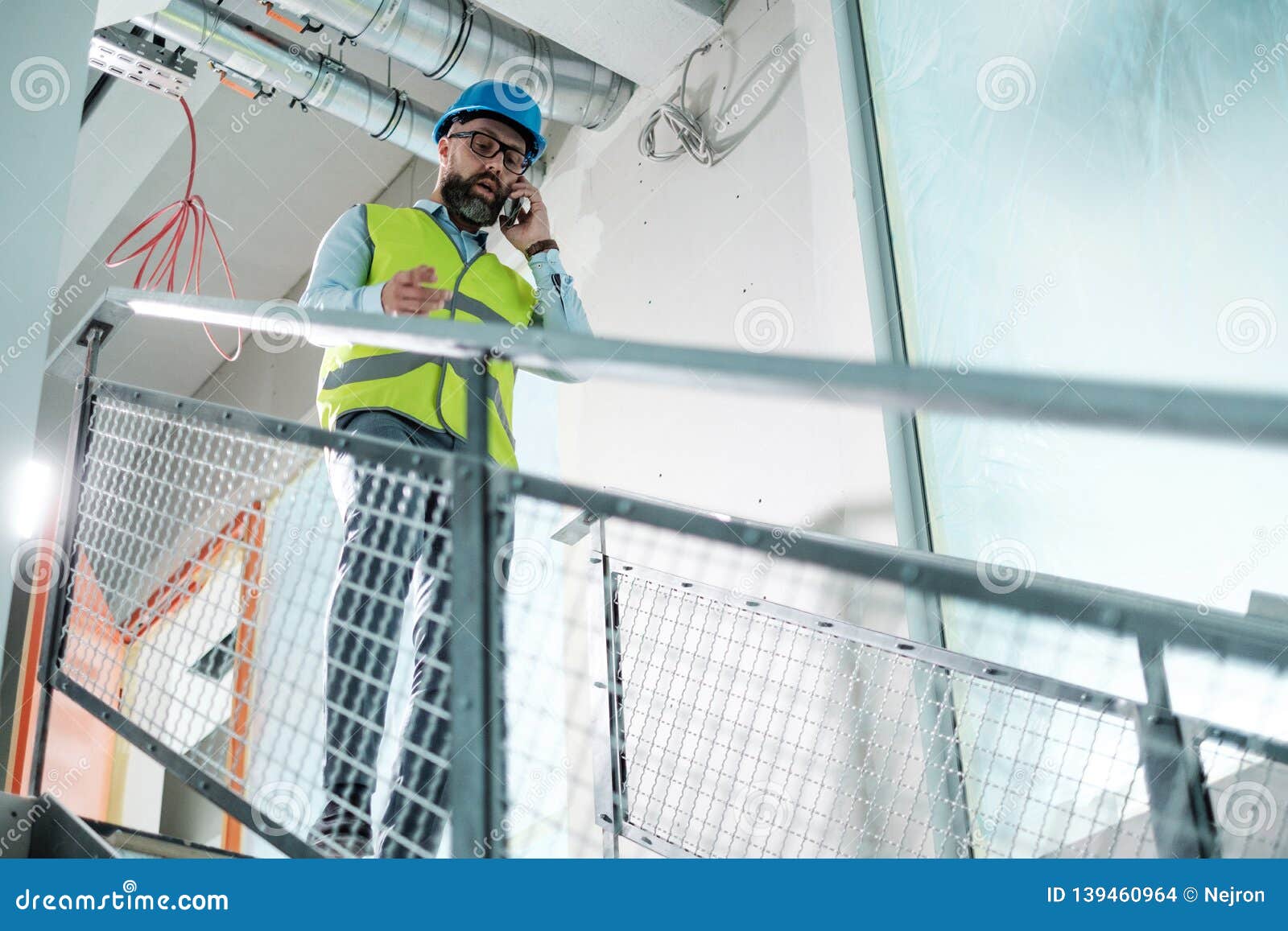 Engineers in Hardhat Calling Someone Stock Photo - Image of blueprint ...