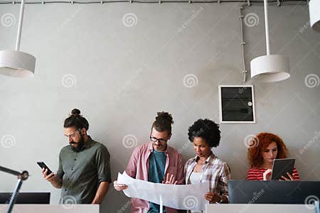 Engineers Helping Design Work on Blueprints, Collaborate on Structural ...