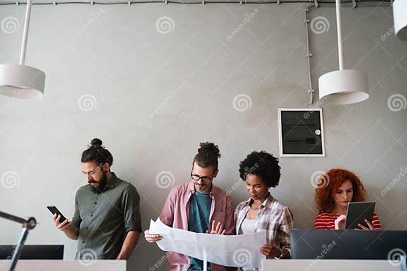 Engineers Helping Design Work on Blueprints, Collaborate on Structural ...