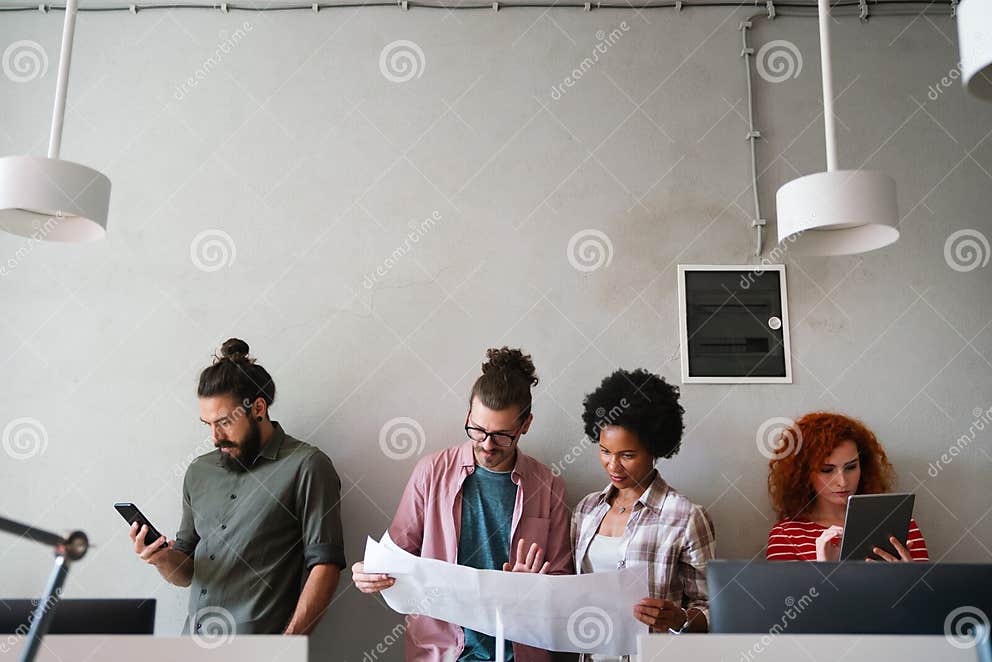 Engineers Helping Design Work on Blueprints, Collaborate on Structural ...