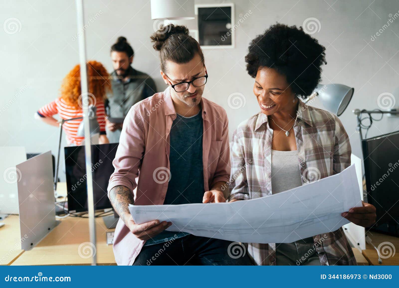 Engineers Helping Design Work on Blueprints, Collaborate on Structural ...