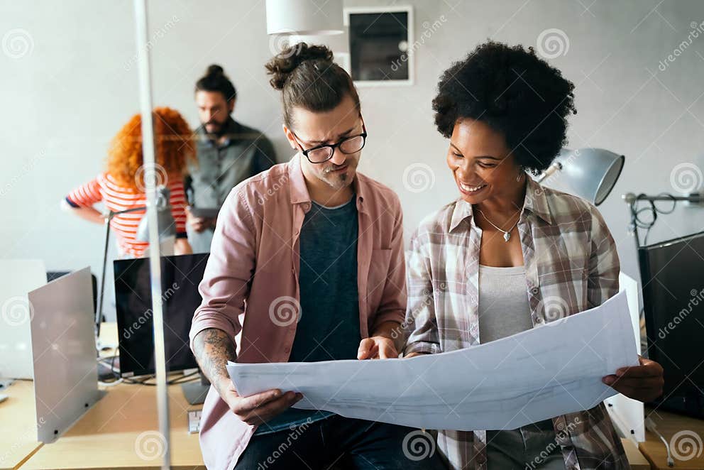 Engineers Helping Design Work on Blueprints, Collaborate on Structural ...