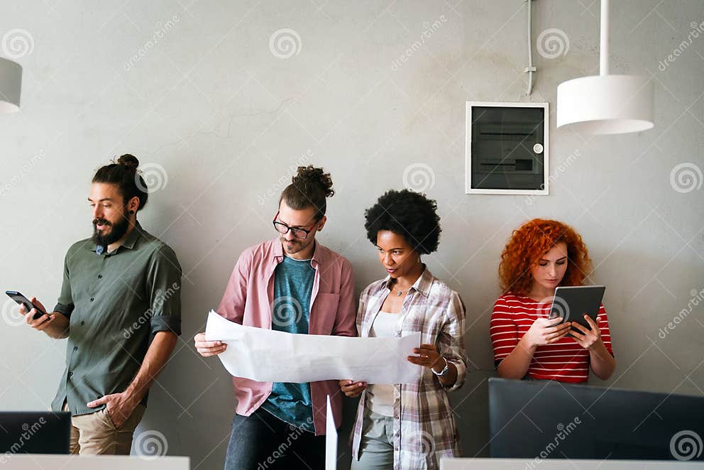 Engineers Helping Design Work on Blueprints, Collaborate on Structural ...