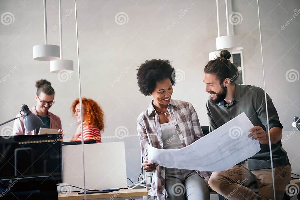 Engineers Helping Design Work on Blueprints, Collaborate on Structural ...