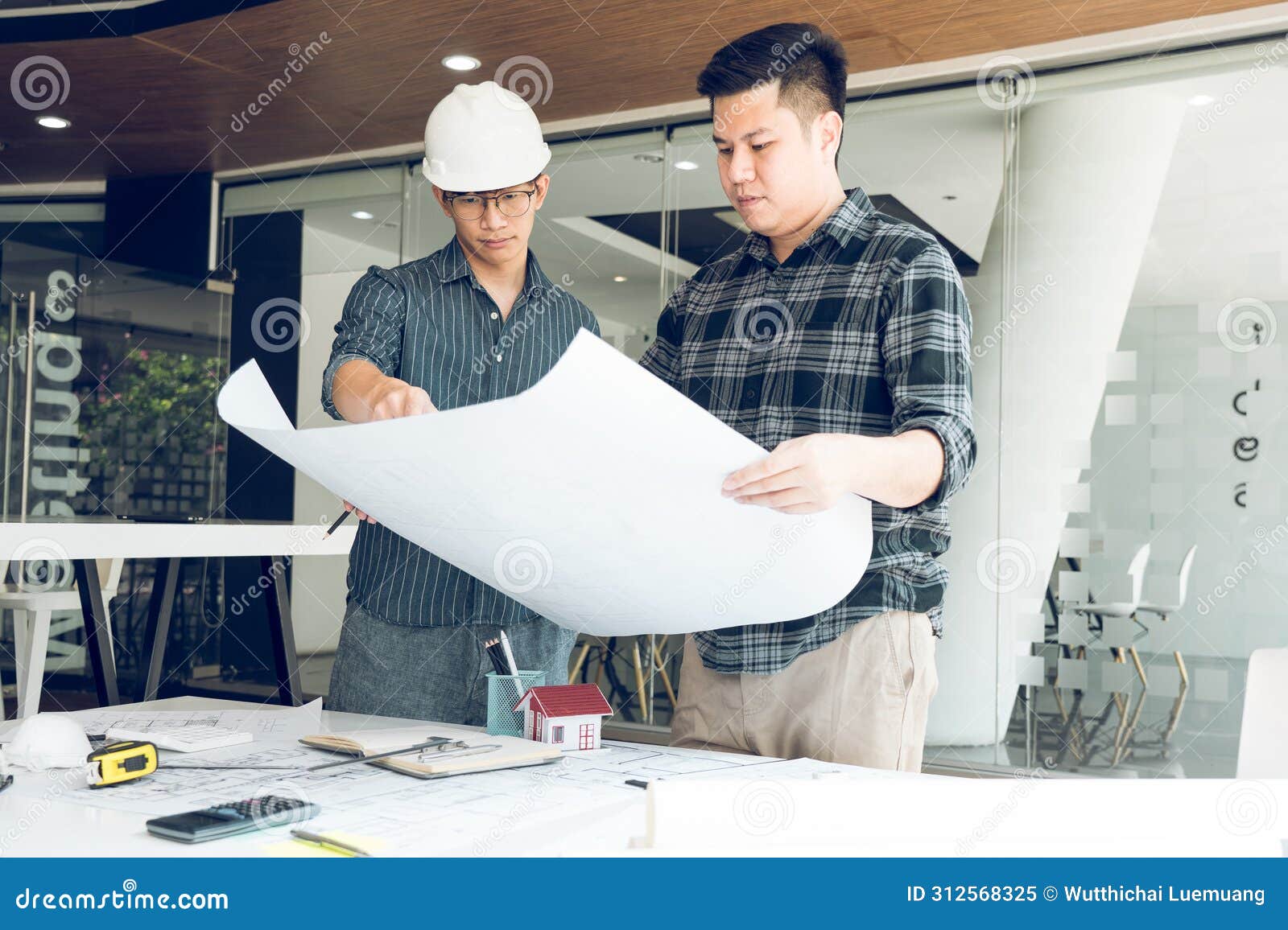 Engineers are Helping To Design Work on Blueprints and Collaborate on ...