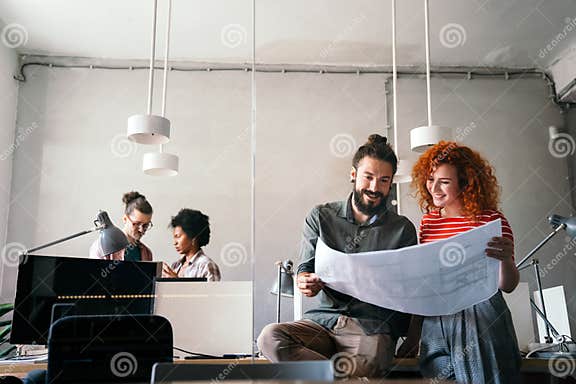 Engineers Helping Design Work on Blueprints, Collaborate on Structural ...